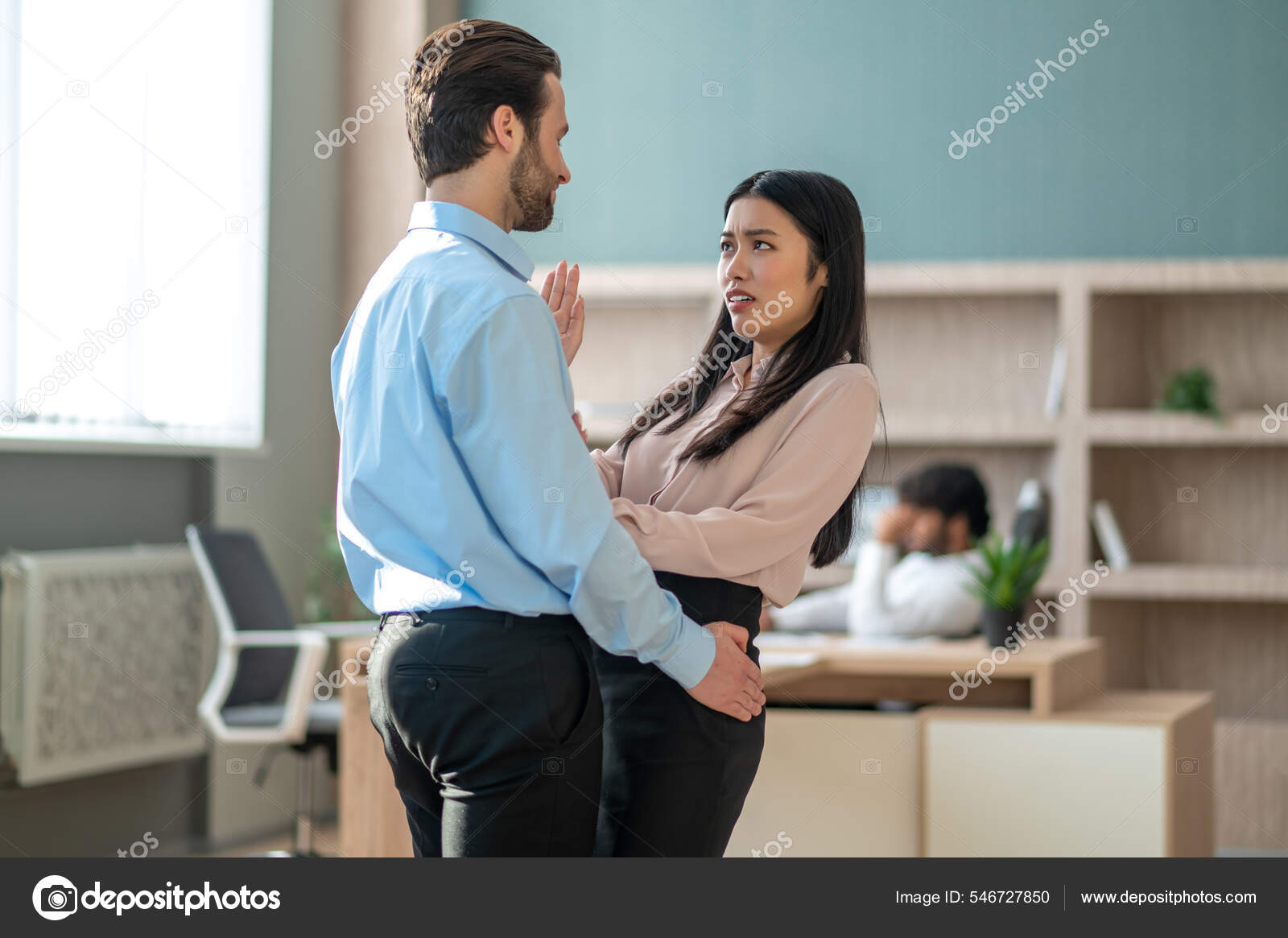 Man behaving improperly with his female colleague in the office — Stock ...