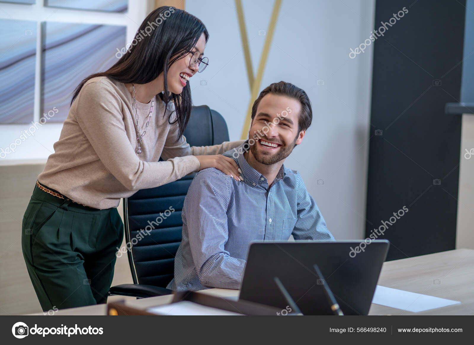 Cheerful personal assistant flirting with her director in his office ...