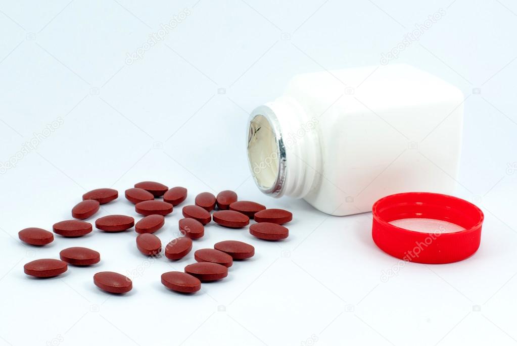 Maroon pills and pill bottle red cap Stock Photo by ©weedezign 48000775
