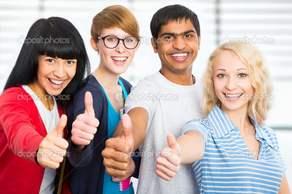 Students giving the thumbs-up sign Stock Photo by ©chagin 44740735