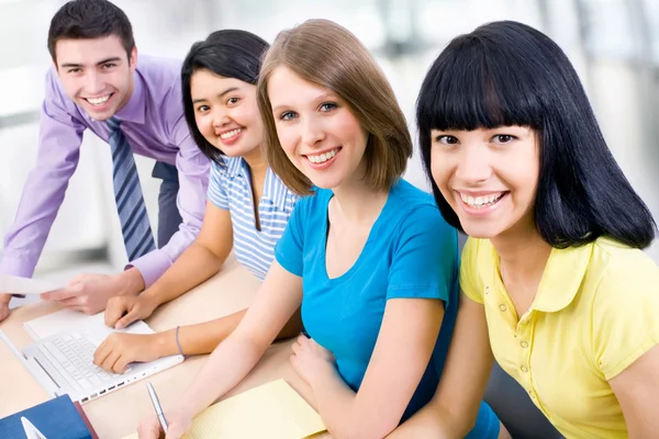 Happy students studying together Stock Photo by ©chagin 44825029