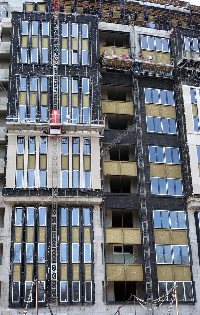 High-rise building under construction with a waterproofing and warming ...