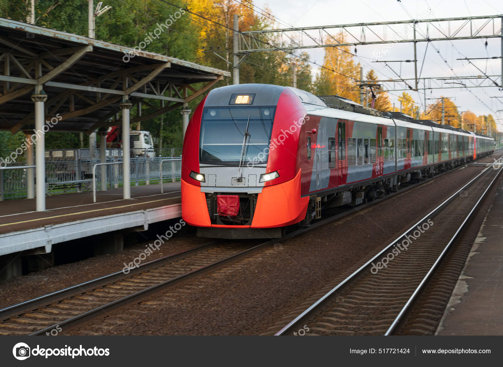 Modern intercity high speed train at sunset. Commercial suburban ...