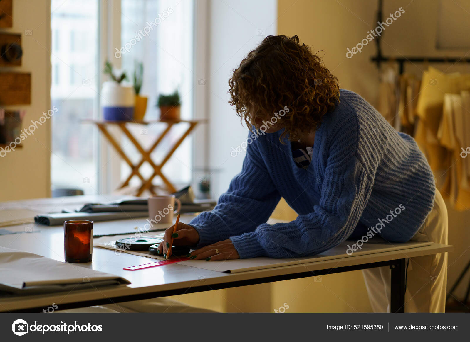 Seamstress draft paper patterns on textile with chalk and ruler ...