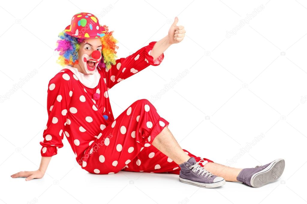 A clown with smiling joyful expression sitting down and giving t Stock ...