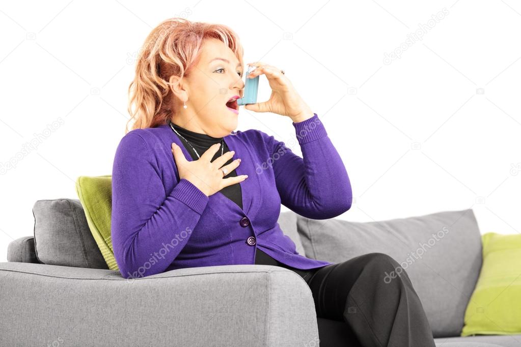 Woman taking asthma treatment with inhaler Stock Photo by ...