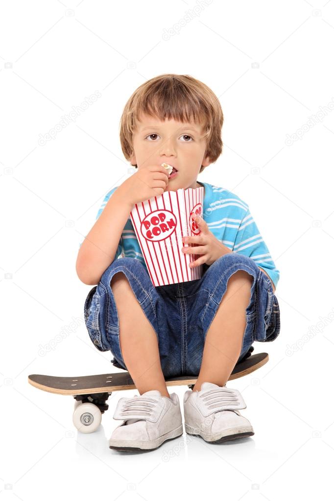 Young boy eating popcorn Stock Photo by ©ljsphotography 45875909