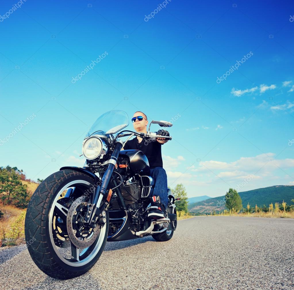 Biker riding motorcycle on road Stock Photo by ©ljsphotography 45881617