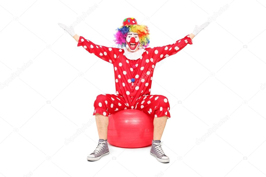Overjoyed clown sitting on a fitness ball Stock Photo by ...