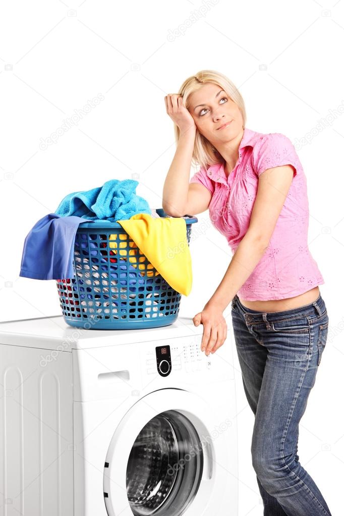 Woman standing by washing machine — Stock Photo © ljsphotography #48310913