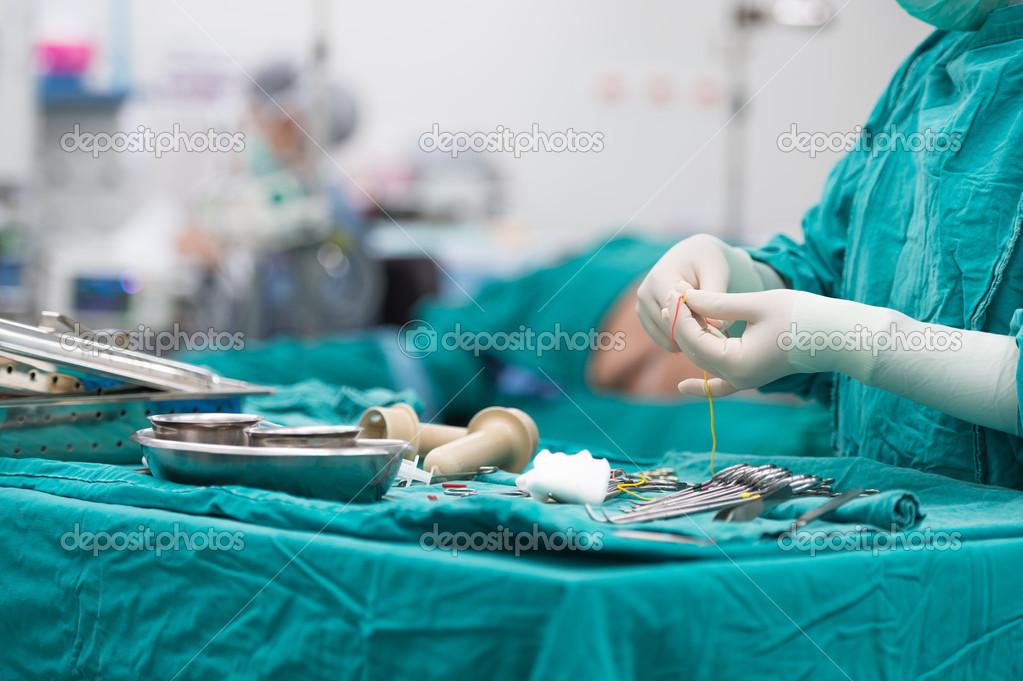 Scrub nurse preparing tools for operation — Stock Photo © chanawit ...