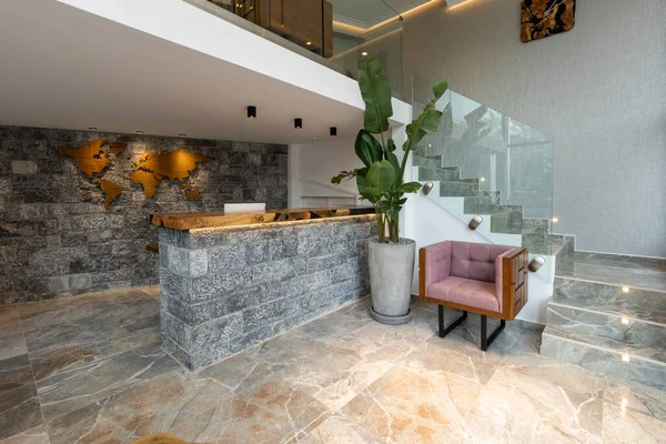 Interior of a hotel reception with stone reception desk - Stock Image ...