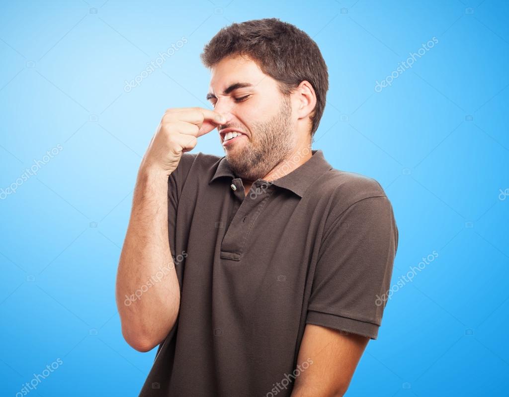 Young man smelling — Stock Photo © AsierRomeroCarballo #47346411