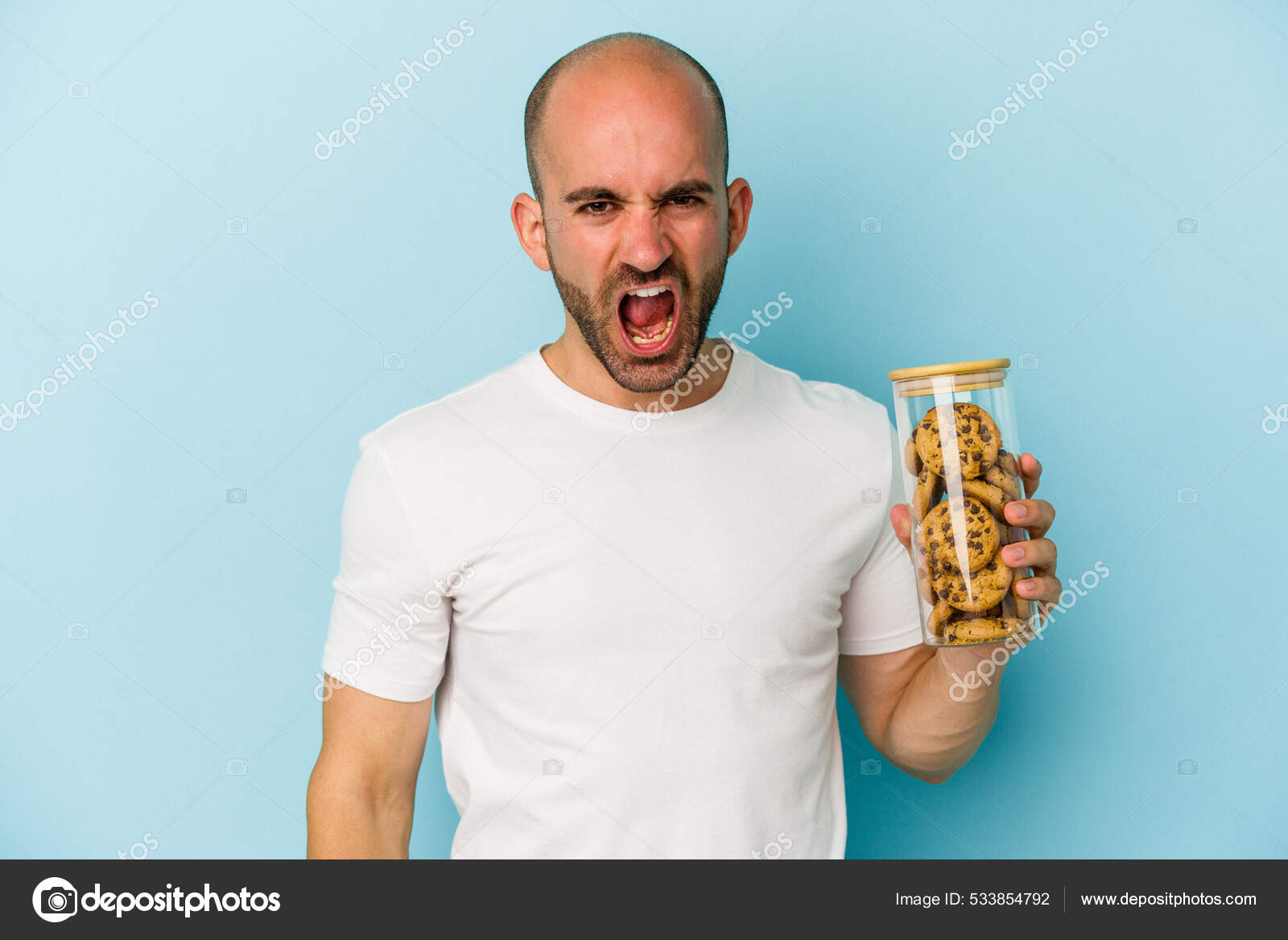 Young Bald Man Holding Cookies Isolated Blue Background Screaming Very ...