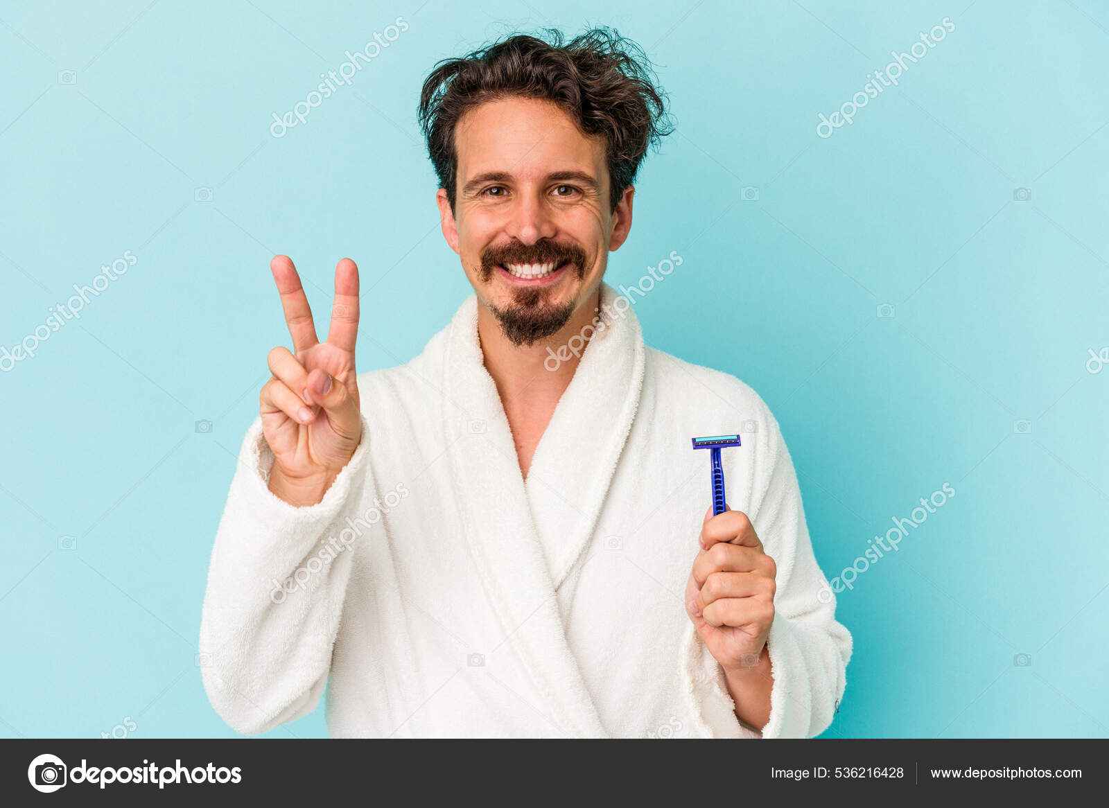 Young Caucasian Man Holding Razor Blade Isolated Blue Background ...
