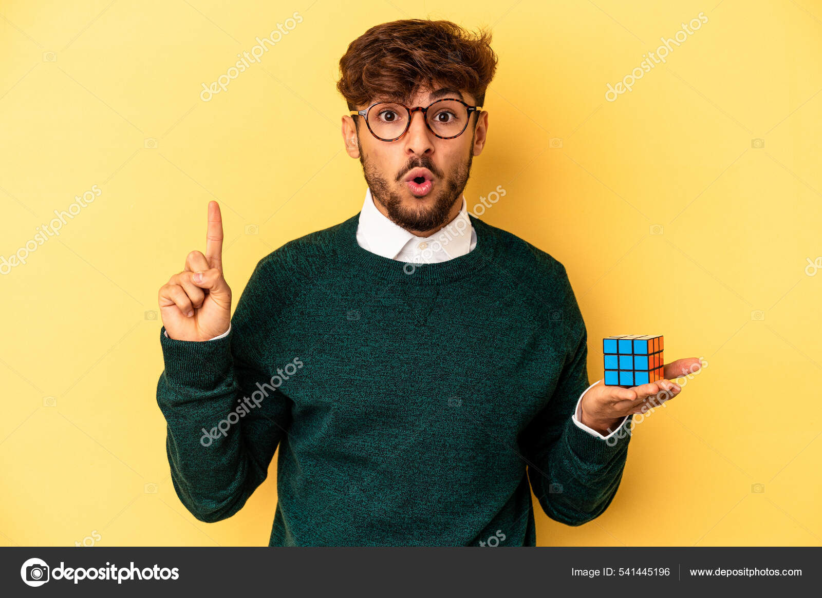 Young Mixed Race Man Holding Rubiks Cube Isolated Yellow Background ...