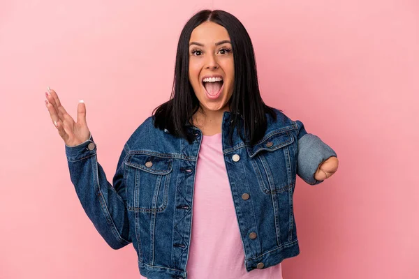 Young caucasian woman with one arm isolated on pink background ...