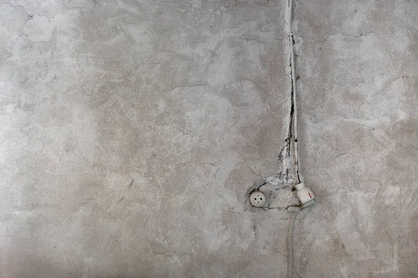 Rustic electrical socket on old limewashed plaster wall, indoor ...