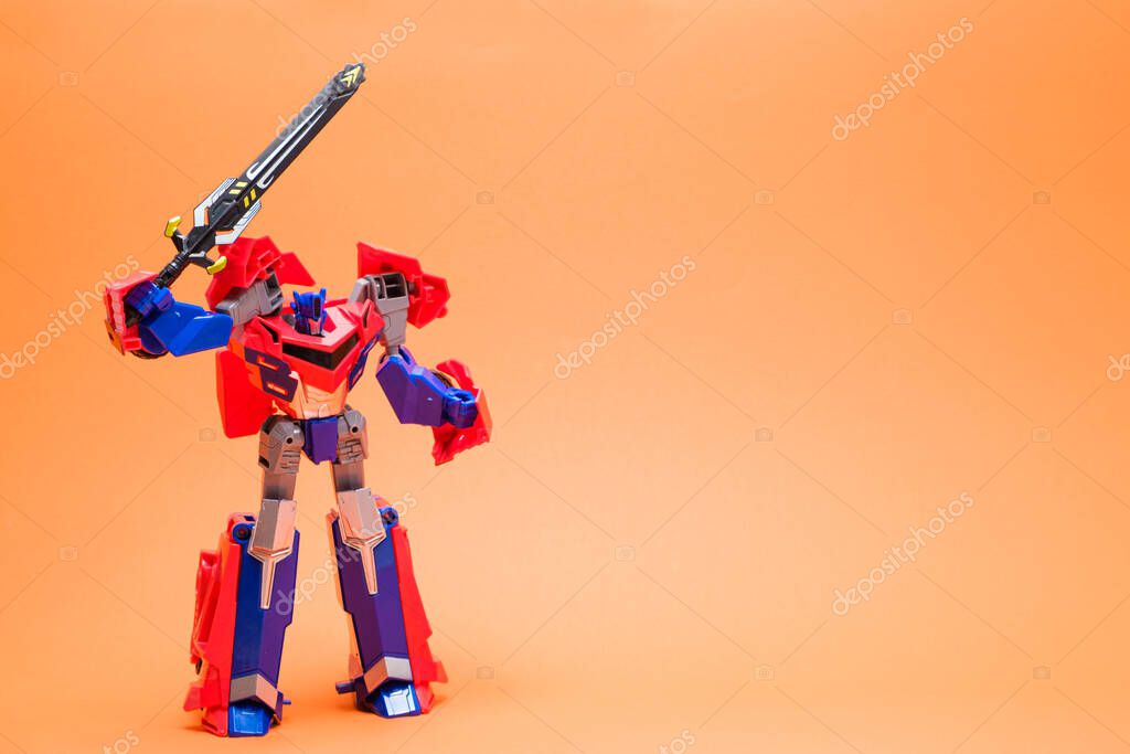 Robot transformer red and blue on an orange background with space for ...