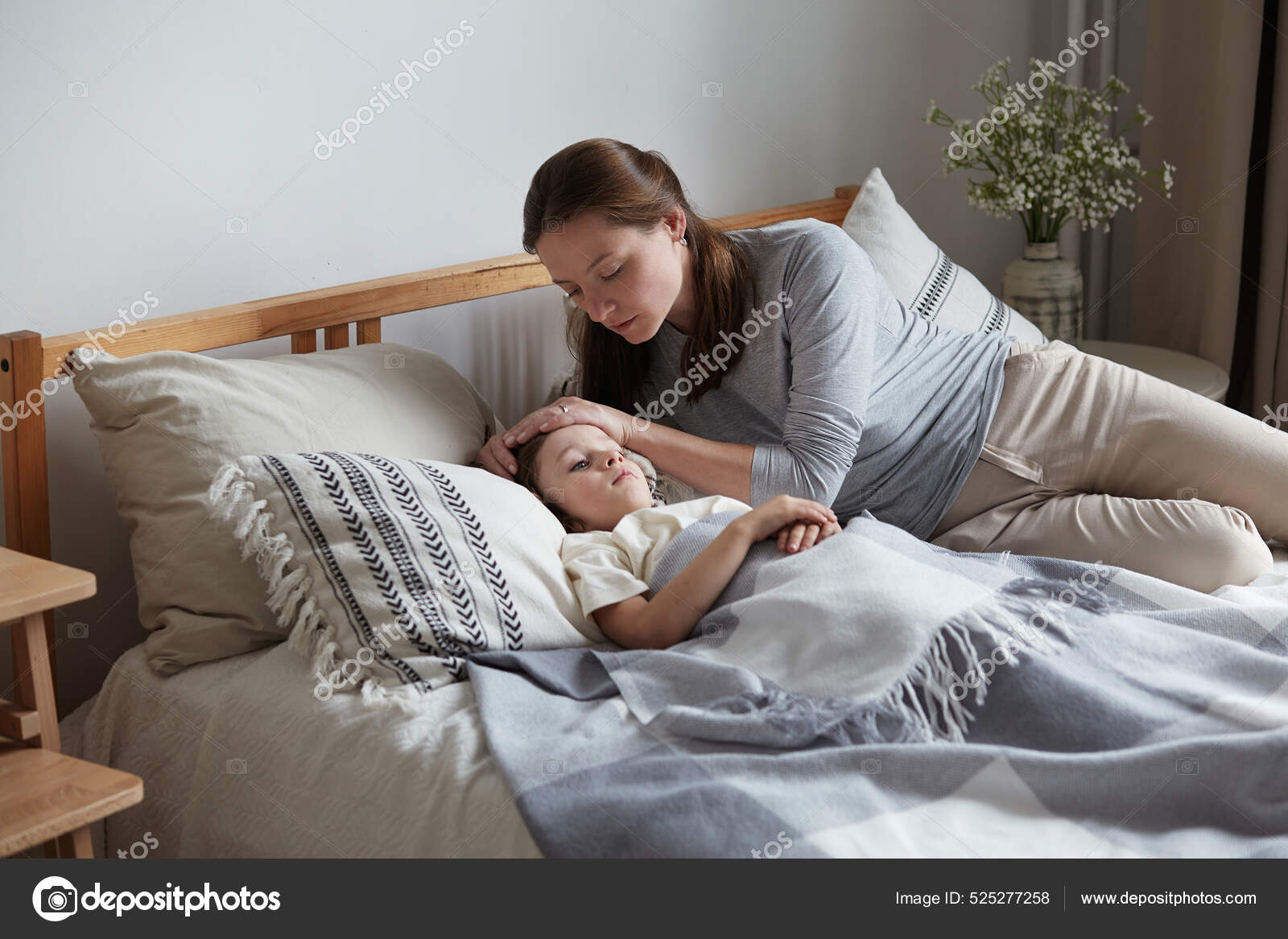 Closeup caring mother touching hot forehead of son checking body temperature worried about ...