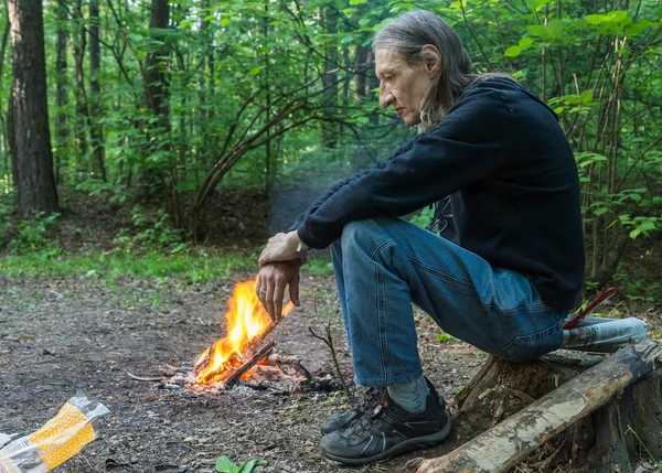 Sad man at a fire - Stock Image - Everypixel