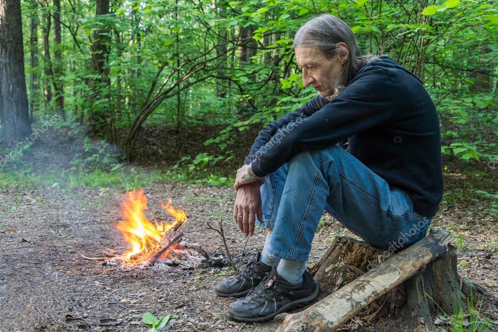 Sad man at a fire Stock Photo by ©sergeypankov 48647371