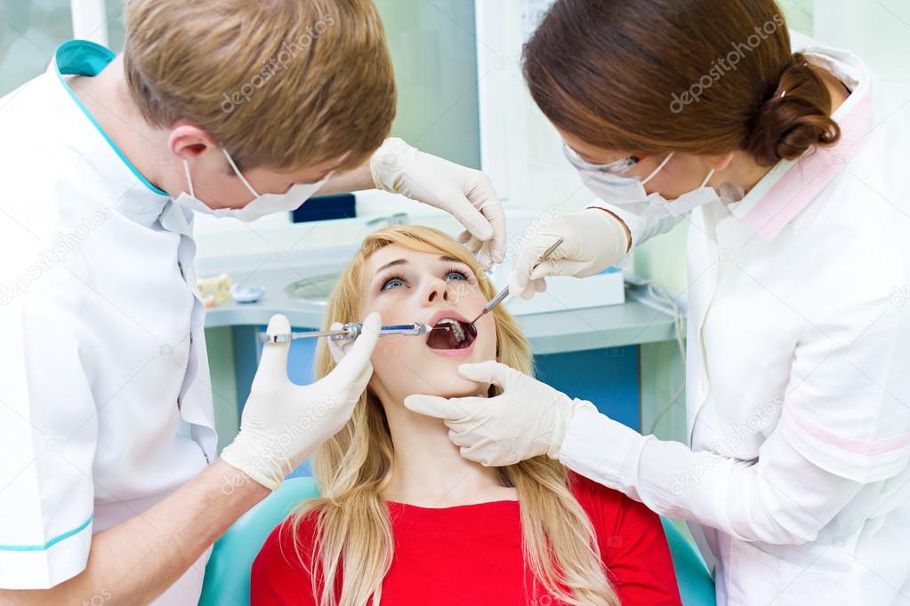 Female patient in detist office geeting anesthetic injection, be Stock ...