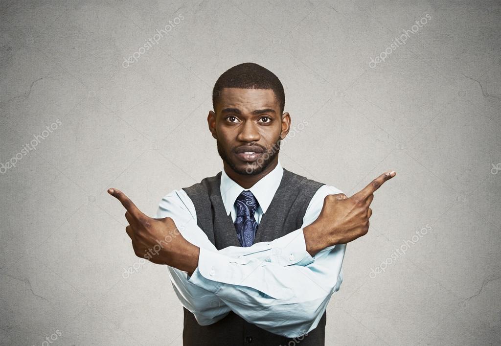 Confused man pointing in two different directions Stock Photo by ...