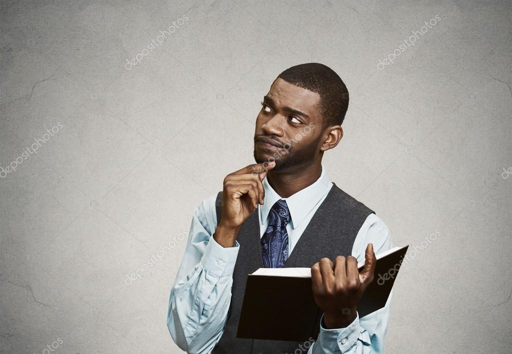 Confused business man reading book, has many questions Stock Photo by ...