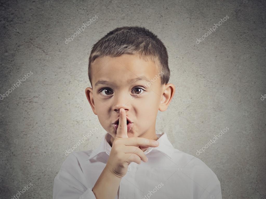 Boy placing finger on lips, quiet gesture — Stock Photo © SIphotography ...