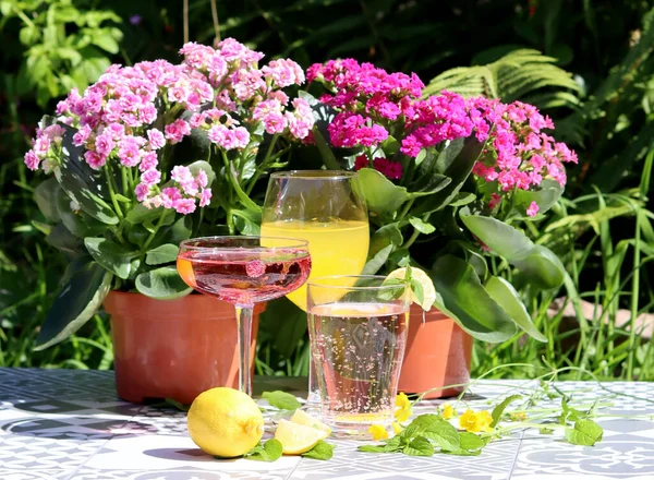 Refreshing summer cocktails on a garden table. Close up photo of ...