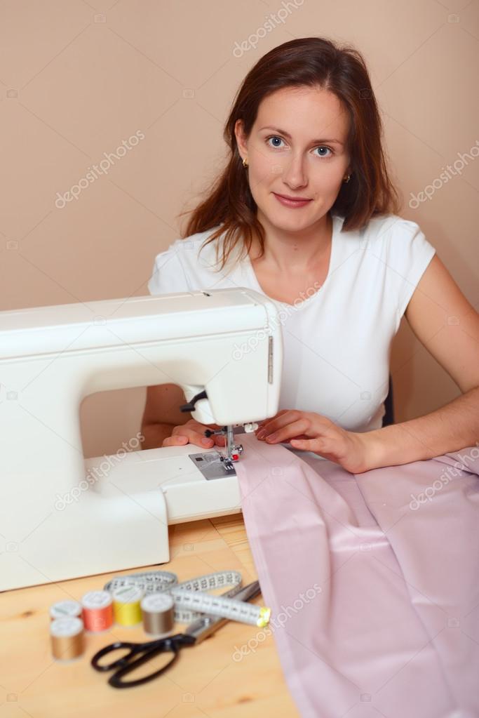 Young attractive woman sewing — Stock Photo © OlgaNiki #48831767