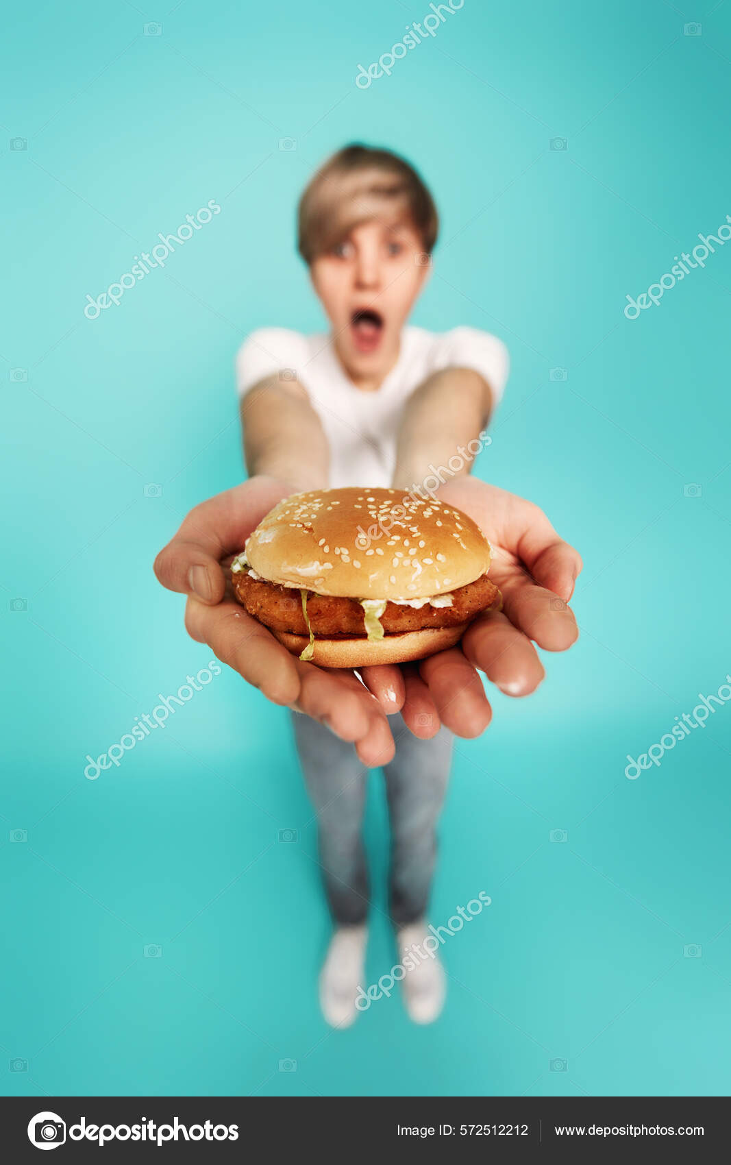 Very hungry young man holding tasty hamburger Stock Photo by ©erstudio ...