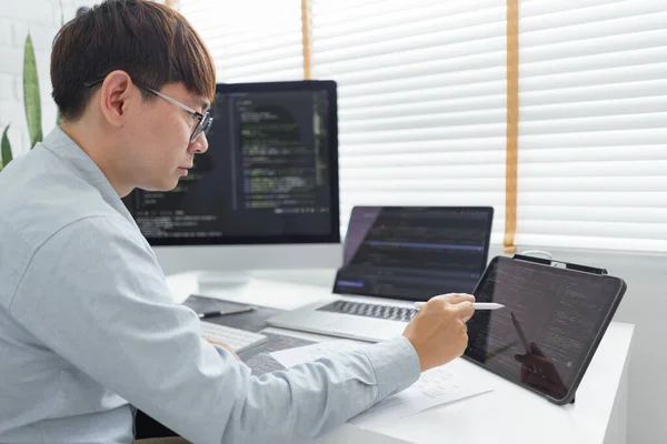 Software development concept, Male programmer point data on tablet to ...