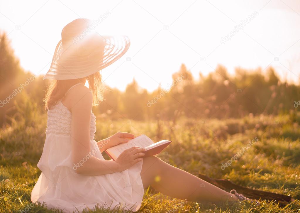 Girl in dress reading book. — Stock Photo © MarinaVlasova #48800345