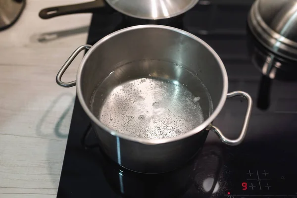 Metal bonfire with boiling water. Preparation for cooking. - Stock ...