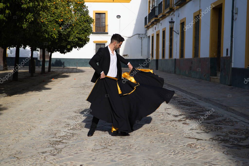 Retrato de un joven y guapo gitano, vestido con zapatos negros y rojos ...
