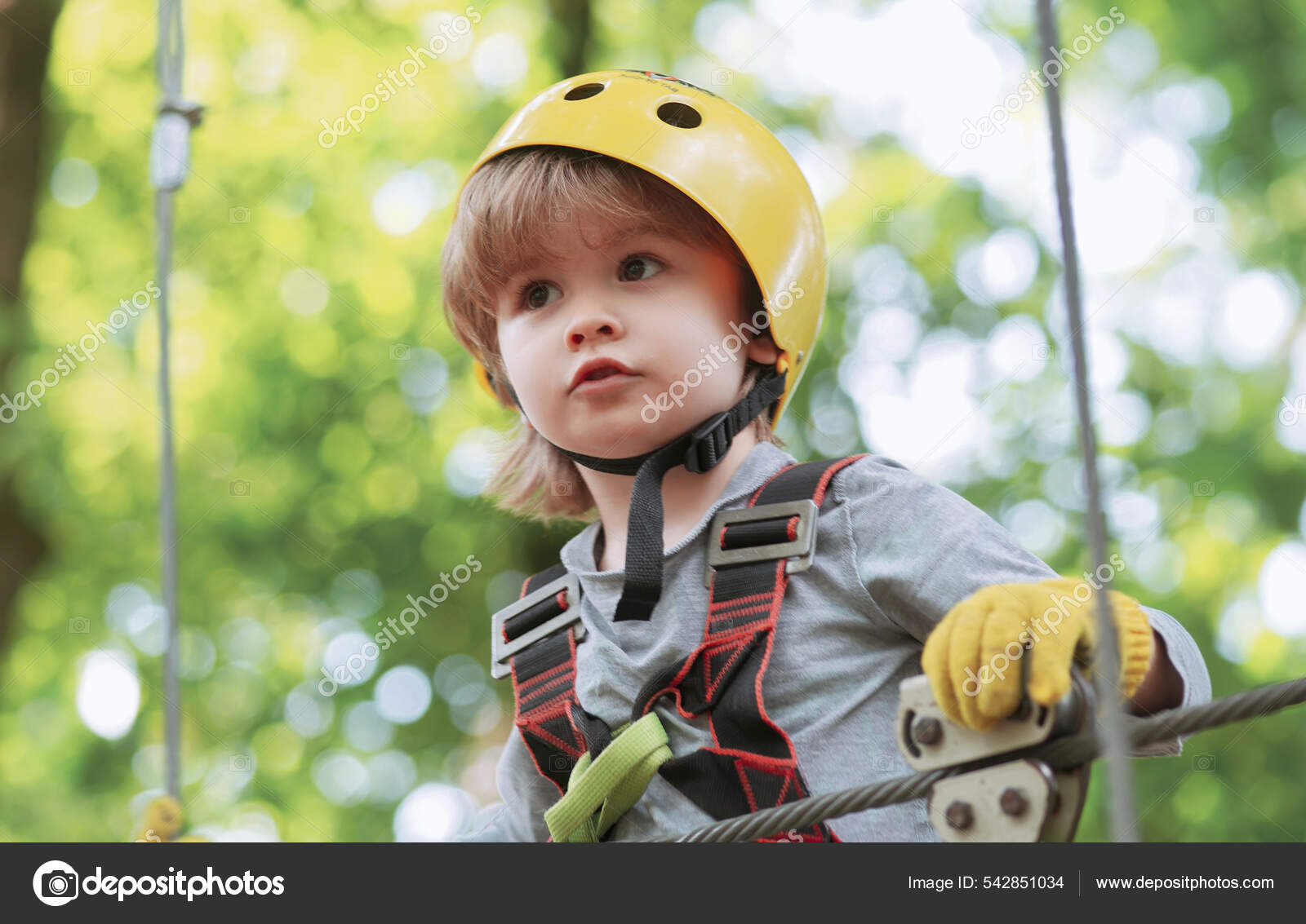 High ropes walk. Helmet and safety equipment. Child concept. Happy ...