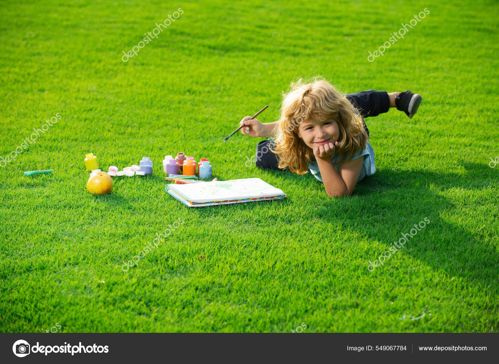 Young talented boy artist painter. Child boy painting with paints color ...