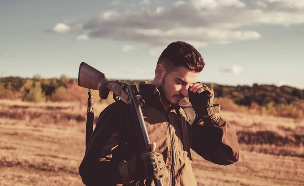 Hunter with Powerful Rifle with Scope Spotting Animals. Hunter with ...