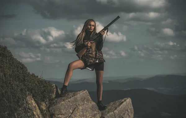 Hunter woman holding gun and walking in forest. Hunter Education Course ...