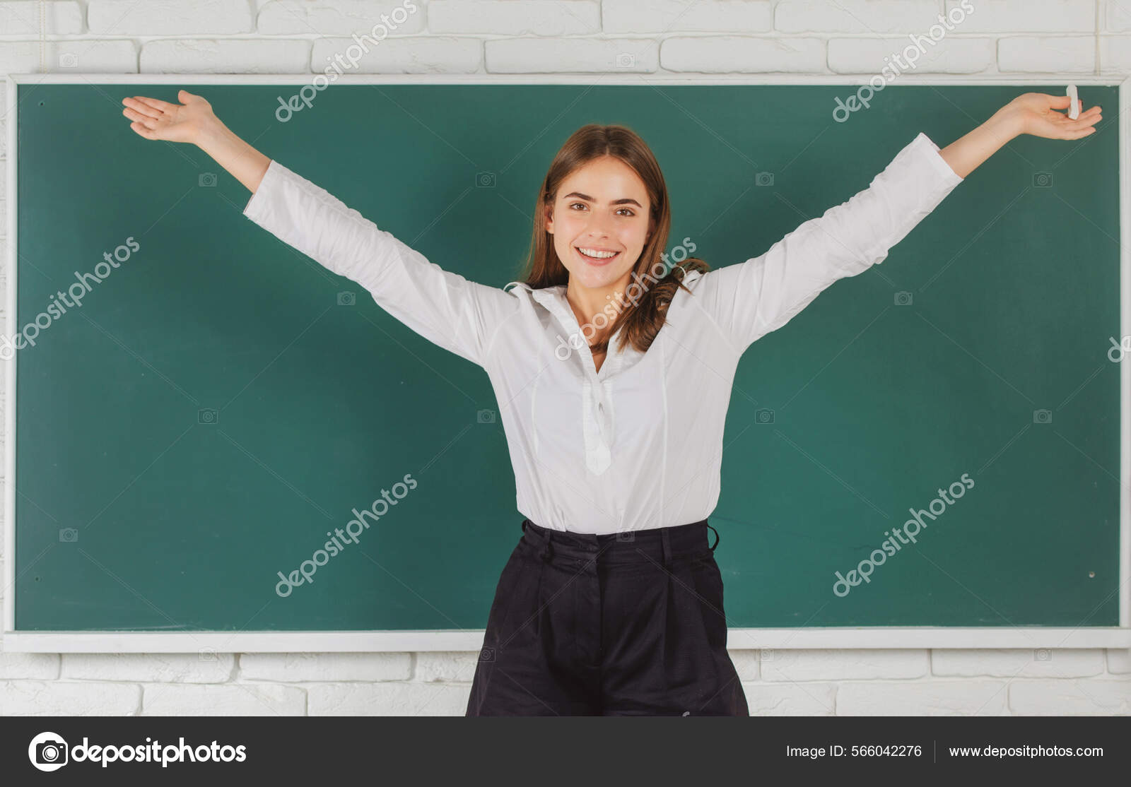 Student excited amazet student with raised hands holding chalk in ...