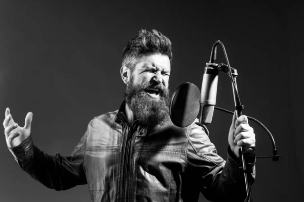 Singer singing rock. Expressive singer with microphone. Sound producer ...