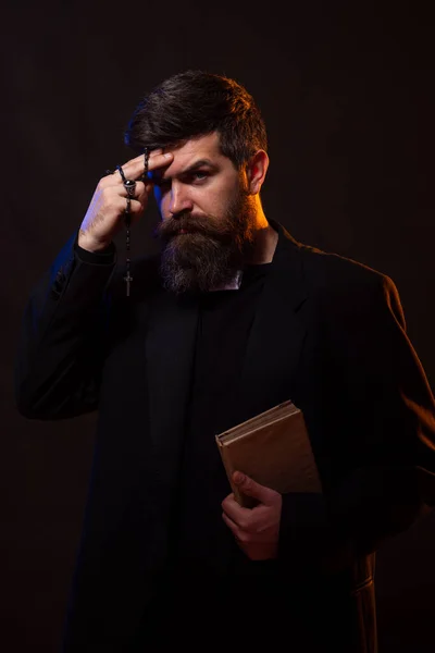 Religion concept. Handsome hispanic catholic priest man over black ...