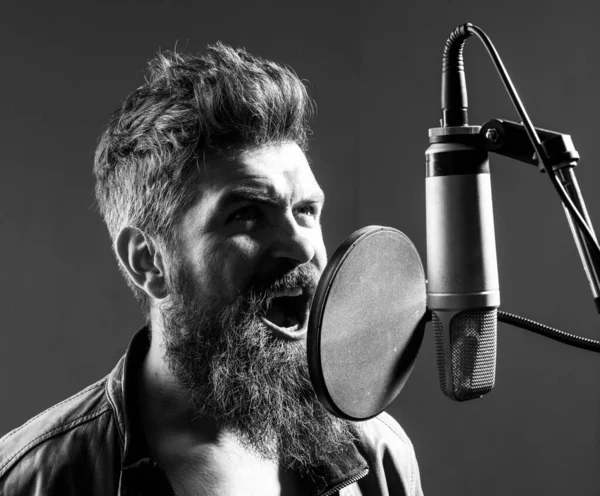 Closeup portrait of man with microphone singing song. Musician in music ...