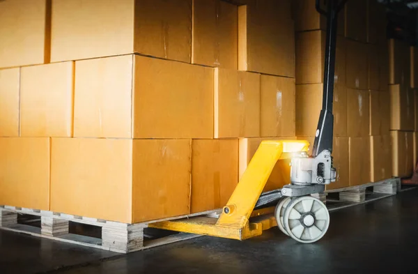Packaging Boxes Stacked on Pallets with Hand Pallet Truck. Cartons ...