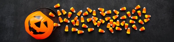 Banner Candy corn candies spilled out of the pumpkin basket ...