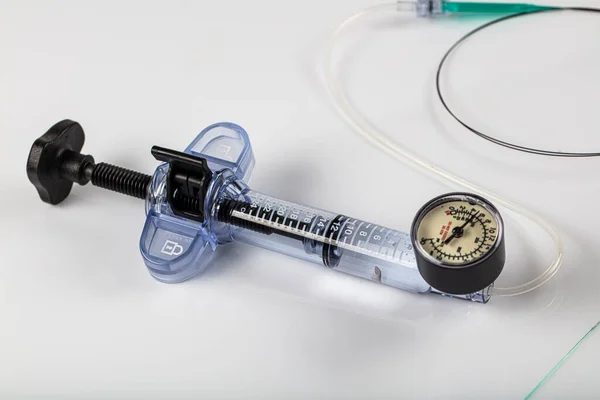 A balloon inflation device used in angioplasty procedure. Mesh metal ...