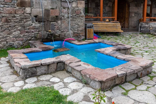 Cross-shaped stone pool with turquoise clear water in Zarzma Monastery ...
