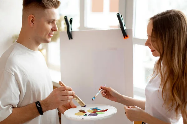 Married couple drawing together. Girlfriend and boyfriend spending time ...